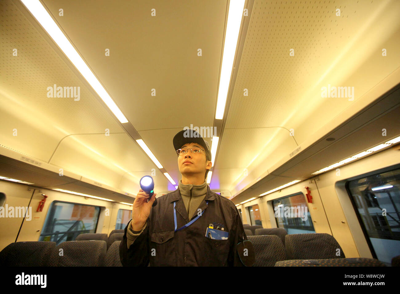 A Chinese worker examines the interior of a CRH (China Railway High ...