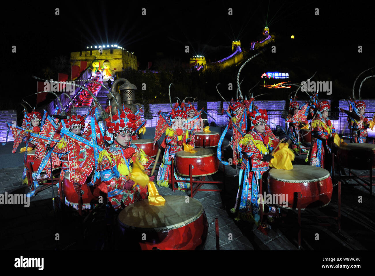 Actresses dressed in Peking Opera costumes play drums during a ...