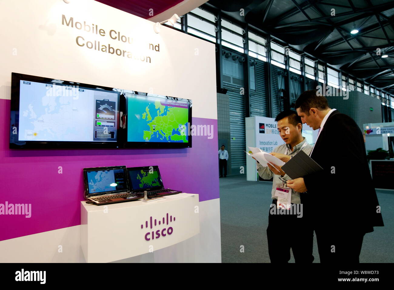--FILE--Visitors are seen in front of the stand of Cisco during the ...