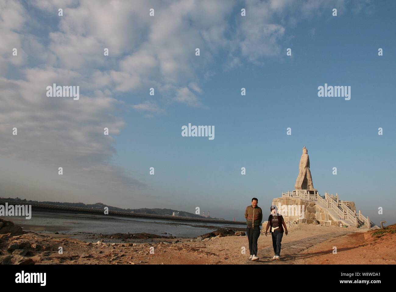 --FILE--Tourists walk along the coastal beach on Jiangong Island in ...