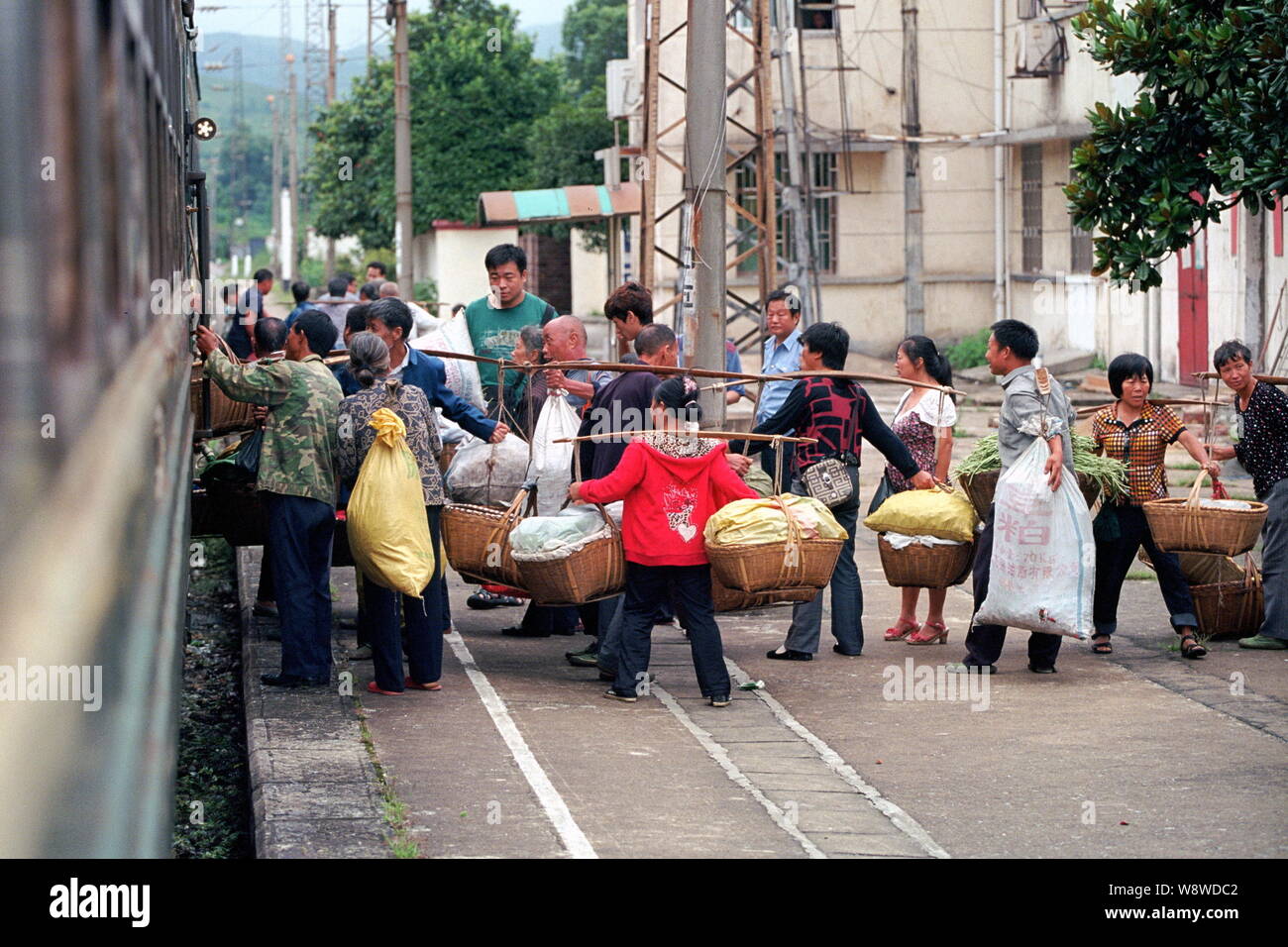 --FILE--Chinese farmers shouldering baskets of vegetables to be sold at ...