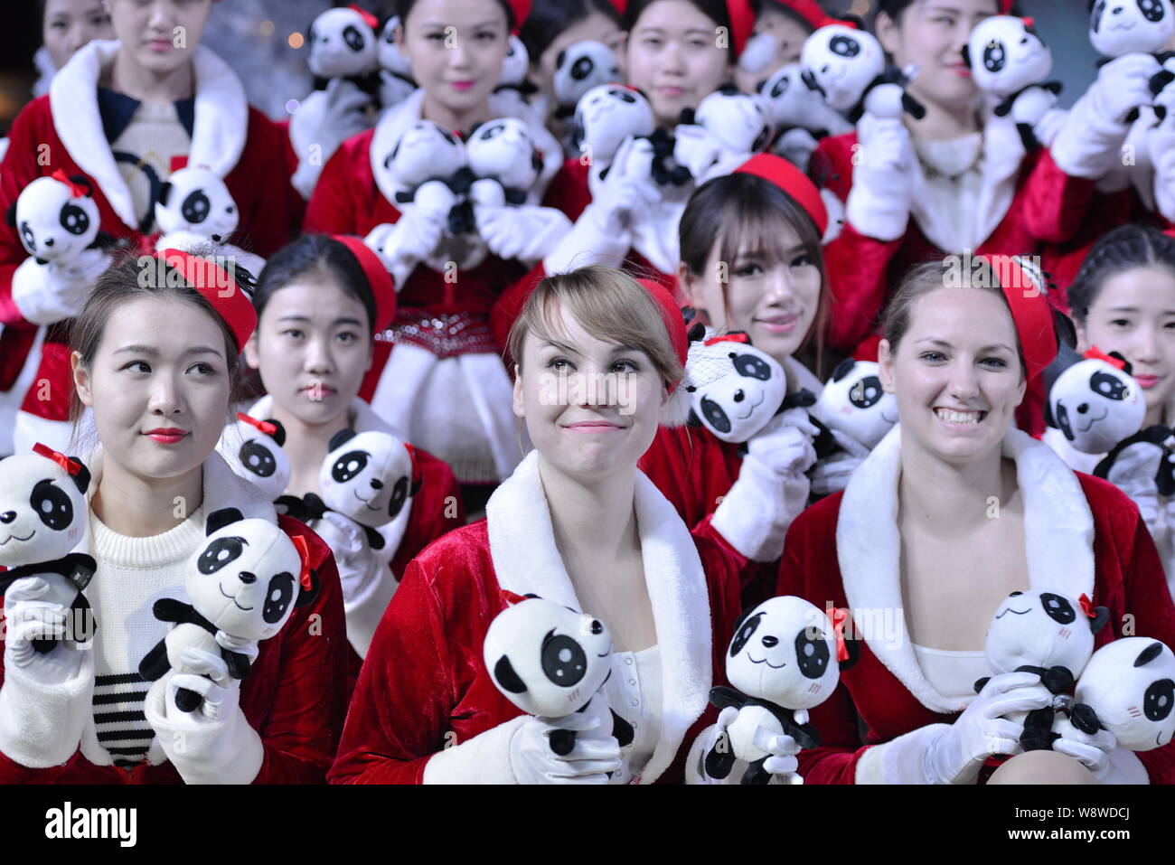 Chinese and foreign girls pose with toy pandas during a parade to ...