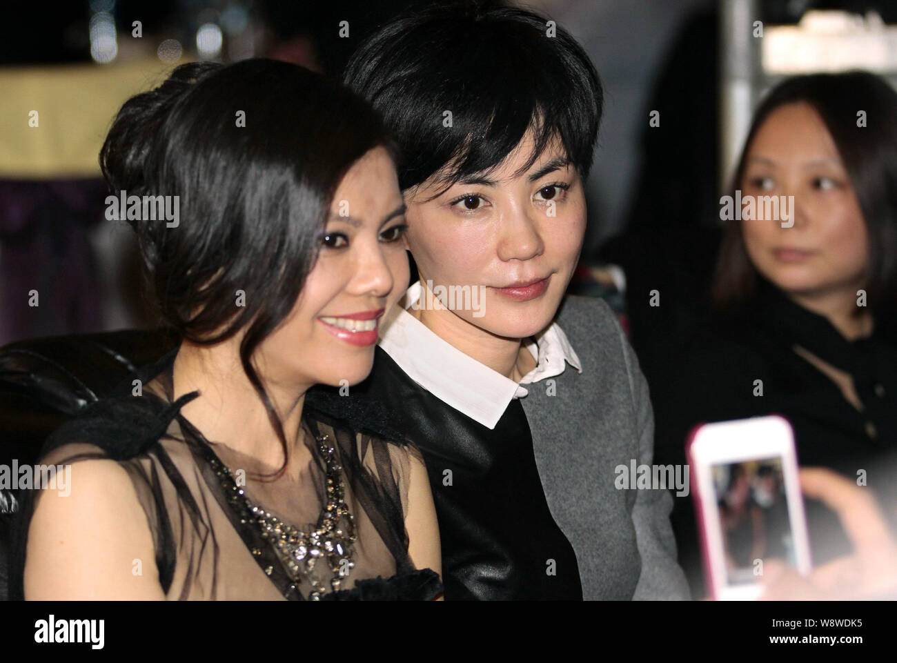 --FILE--Chinese socialite and singer Zhao Xinyu, left, and Hong Kong singer Faye Wong pose for ...