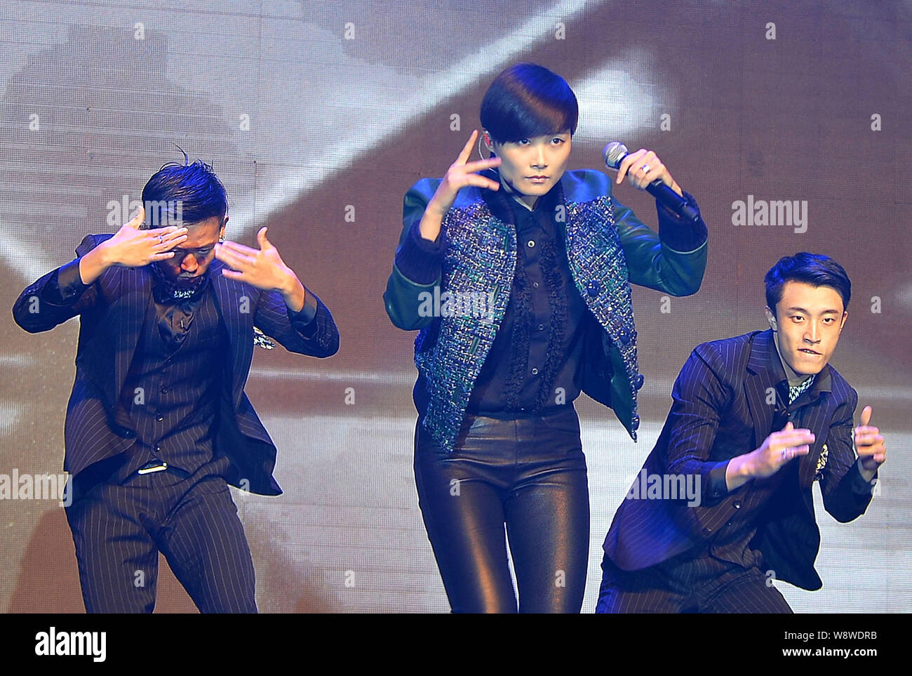 Chinese singer Li Yuchun, center, performs during a press conference for her new album, 1987, in ...