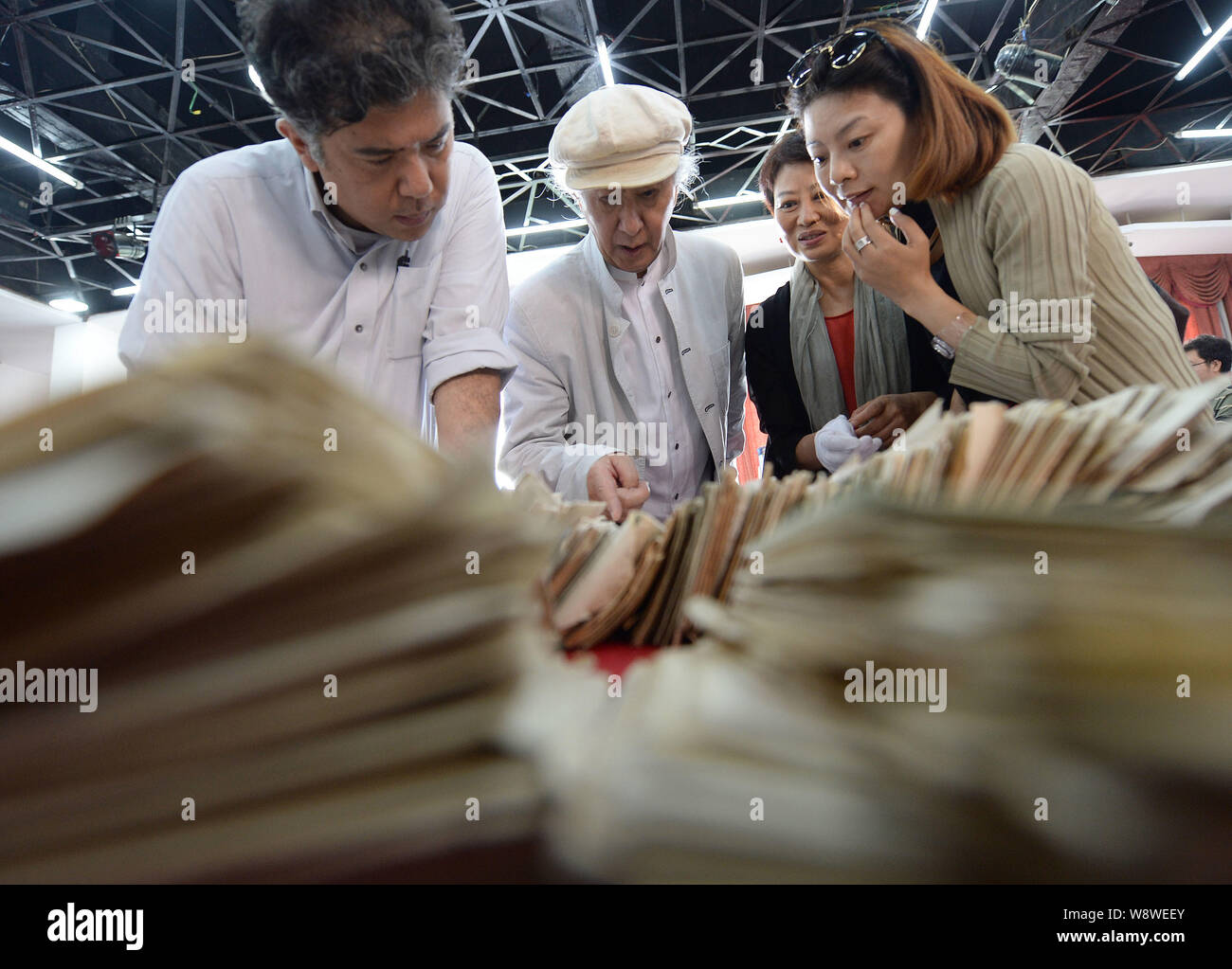 Japanese architect Arata Isozaki, second left, and other visitors look ...
