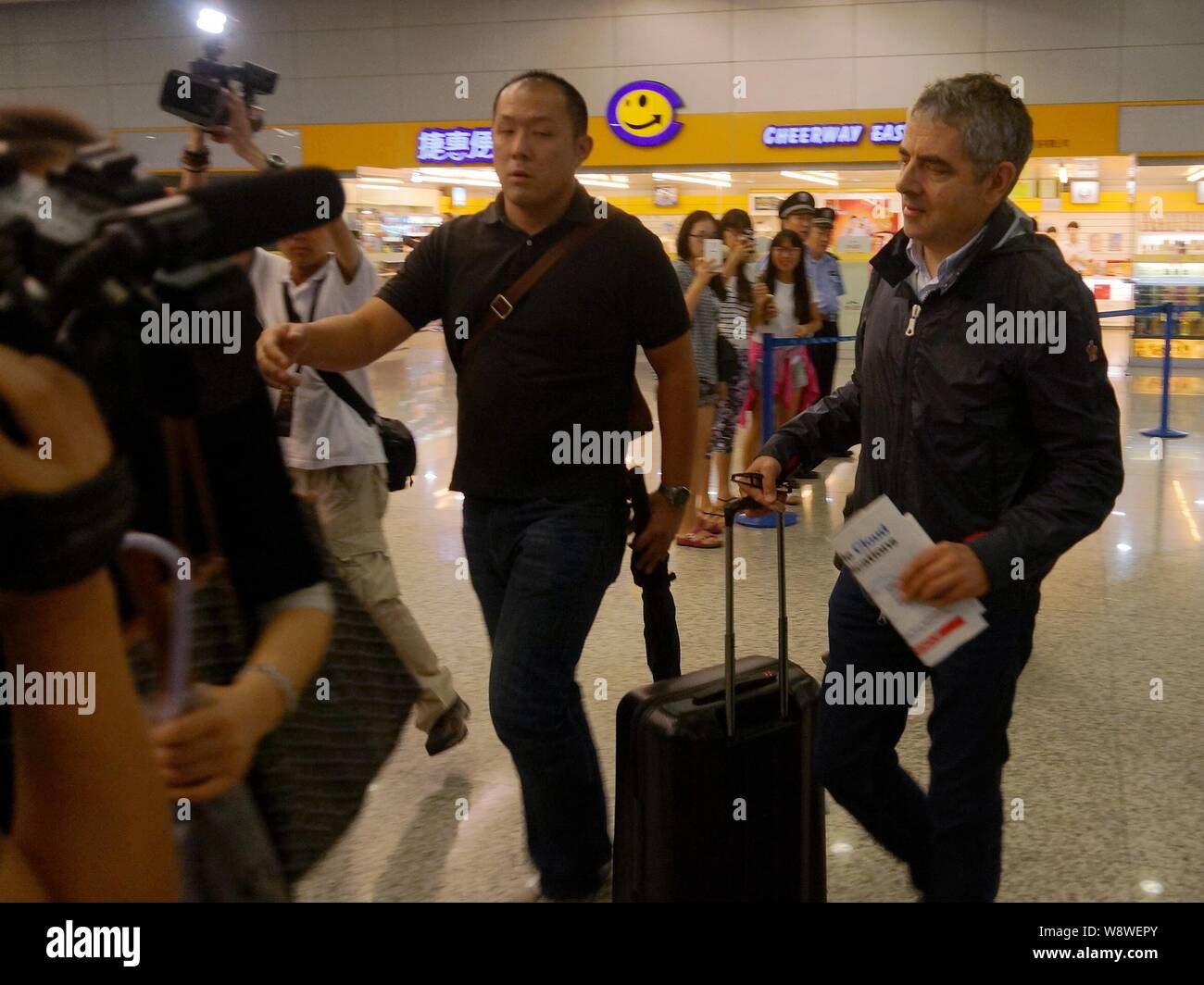 English actor Rowan Atkinson, right, arrives at the Shanghai Pudong ...