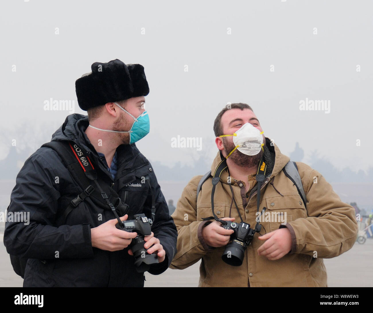 Foreign tourists wearing face masks visit the Tiananmen Square in heavy ...