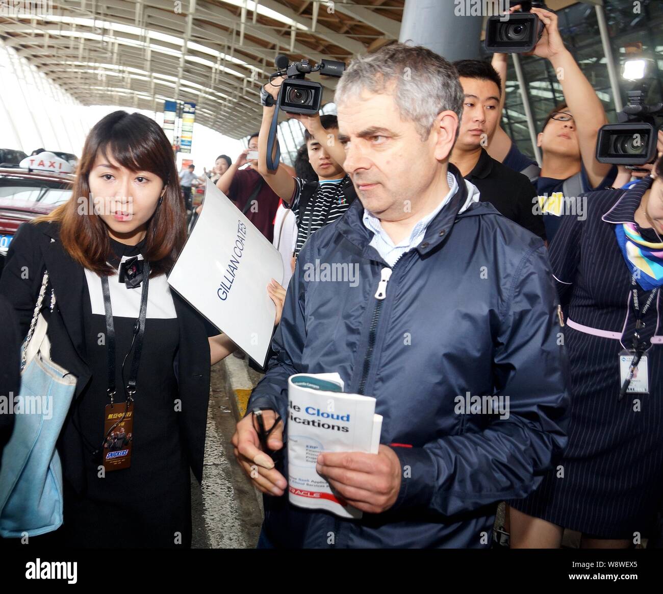 English actor Rowan Atkinson, front, arrives at the Shanghai Pudong ...