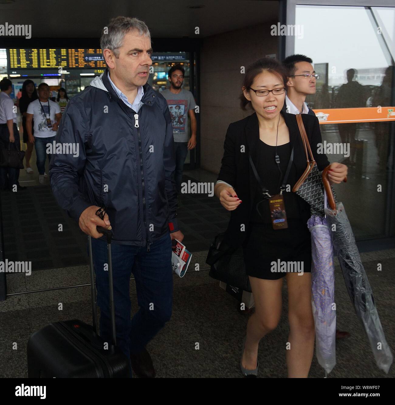 English actor Rowan Atkinson, left, arrives at the Shanghai Pudong ...