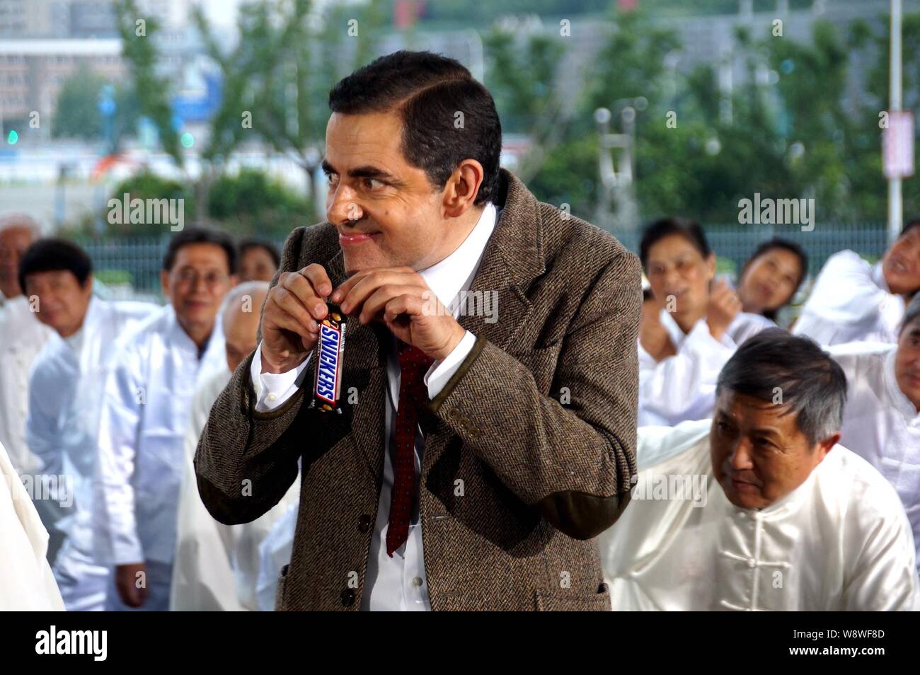 English actor Rowan Atkinson, front, plays Mr. Bean during a filming session for a TV commercial ...