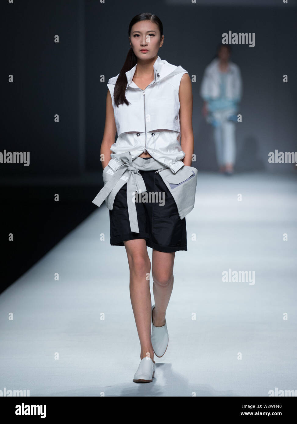 A model displays a new creation by designer Zhu Wen at the Yante Tree ...