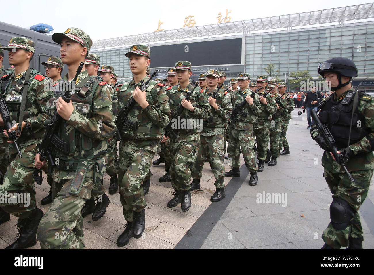 SWAT police officers armed with guns patrol at the square of the ...