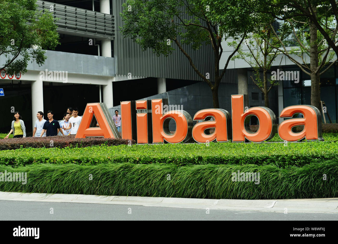 --FILE--Chinese employees walk at the headquarters of Alibaba Group in ...