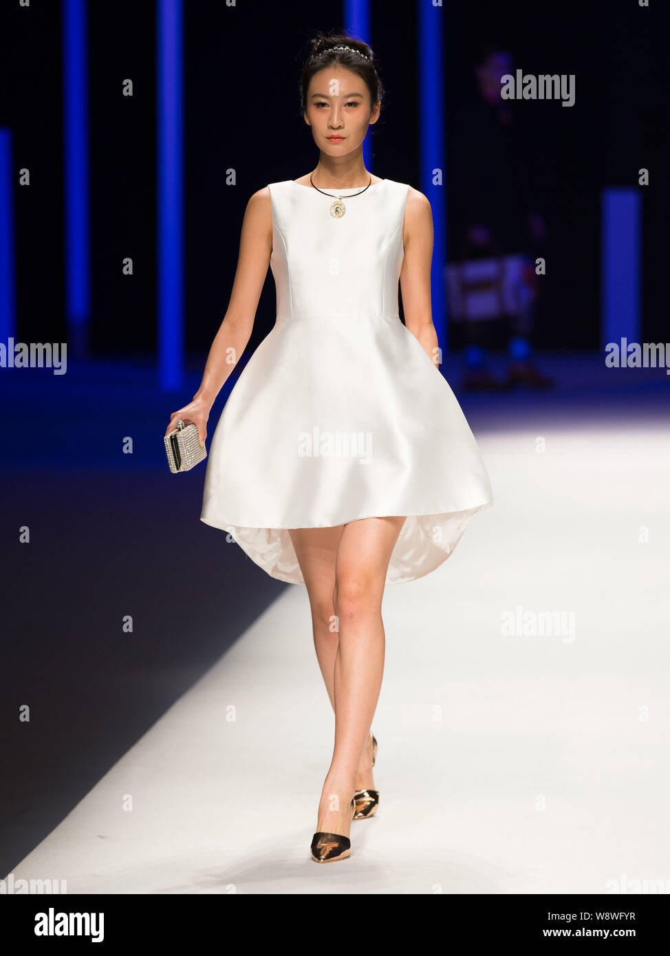 A model displays a new creation by designer Yuan Bing at the VISCAP ...