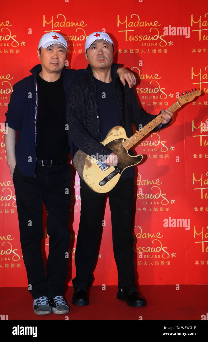 Chinese singer-songwriter Cui Jian, left, poses with the wax figure of ...