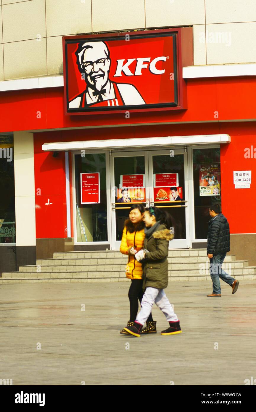 --FILE--Pedestrians walk past a KFC fastfood restaurant in Yichang city ...