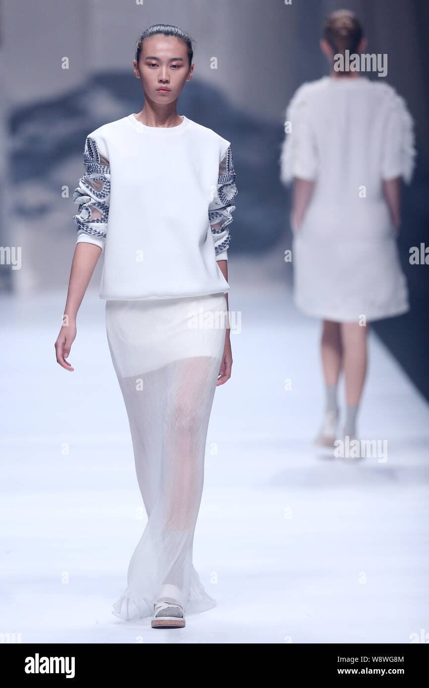 A model displays a new creation at the fashion show of Ji Cheng during ...