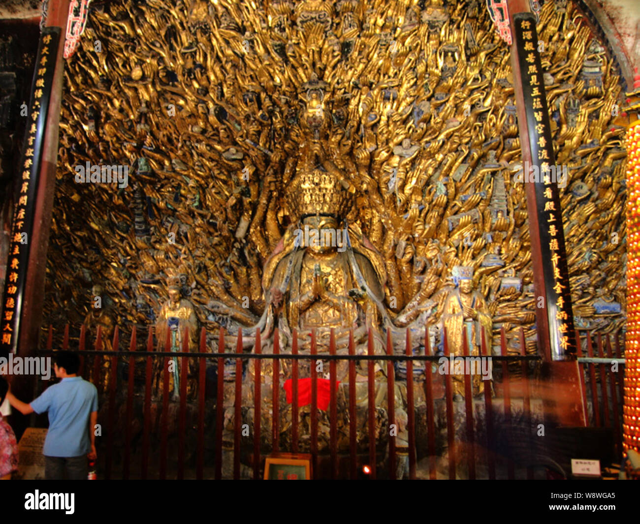 Tourists look at Dazu rock carvings on Mount Baoding, or Bao Ding ...