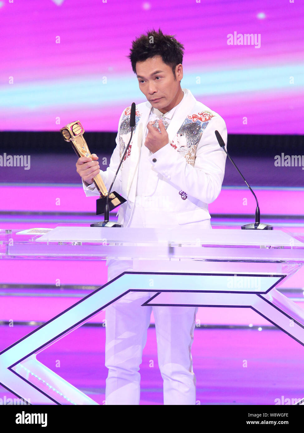 Hong Kong actor Roger Kwok holds his trophy after winning the Best ...