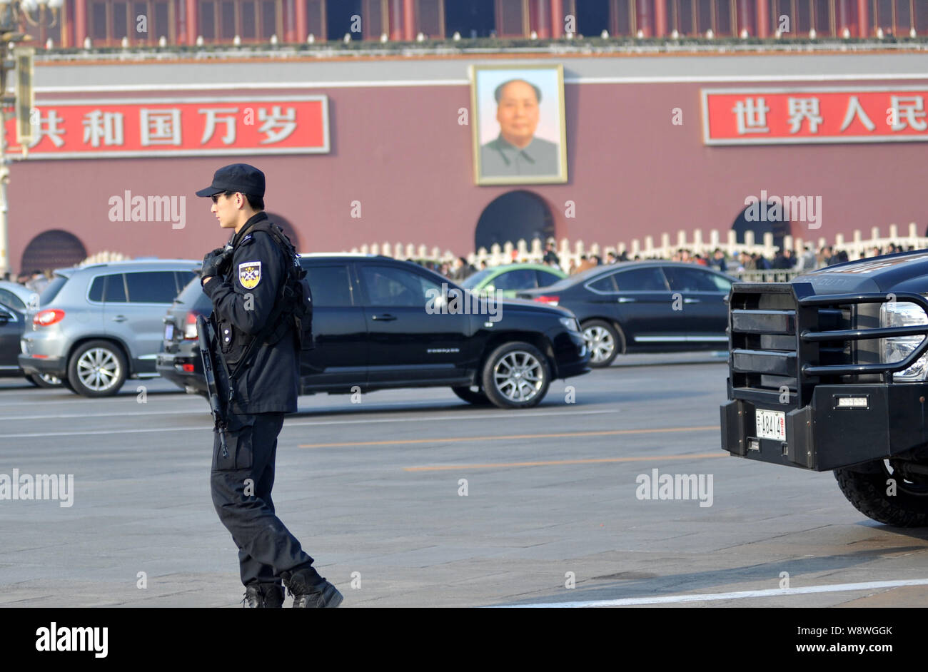 An armed police officer stands guard at the Tiananmen Square in Beijing ...