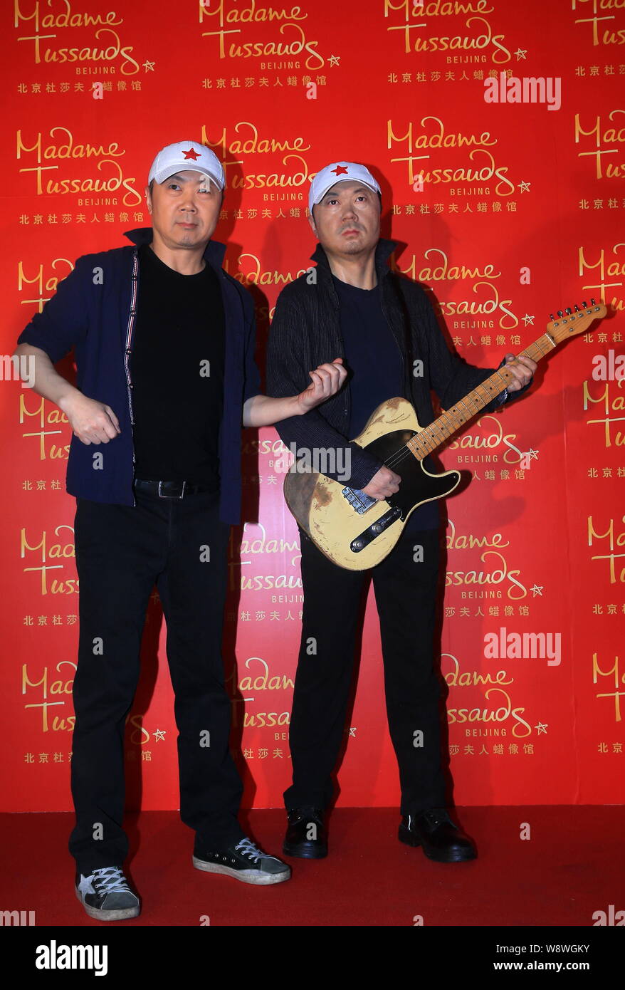 Chinese singer-songwriter Cui Jian, left, poses with the wax figure of ...