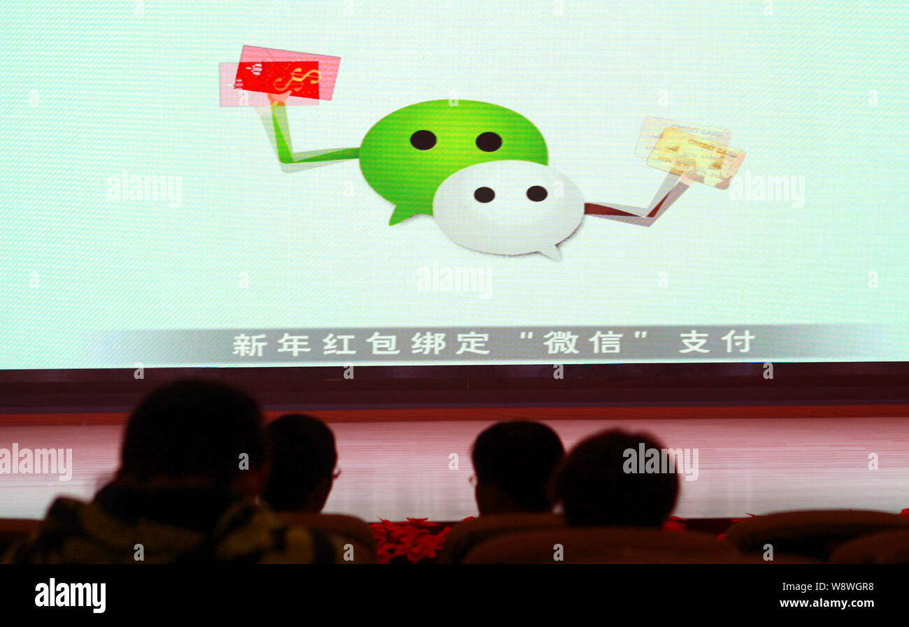 --FILE--Trainees look at a logo of the mobile messaging app Weixin, or ...