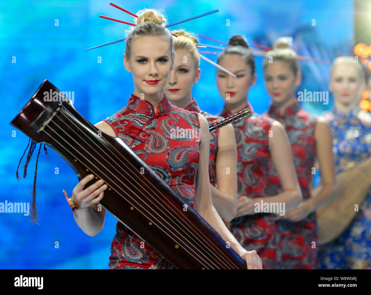 Chinese and foreign models display creations of cheongsam, also known ...