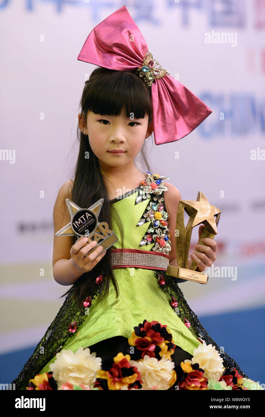 6-year-old Chinese child model Zhou Ziling poses with the trophies she ...