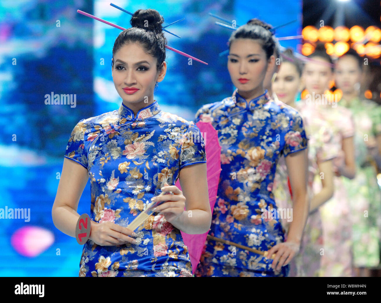 Chinese and foreign models display creations of cheongsam, also known ...