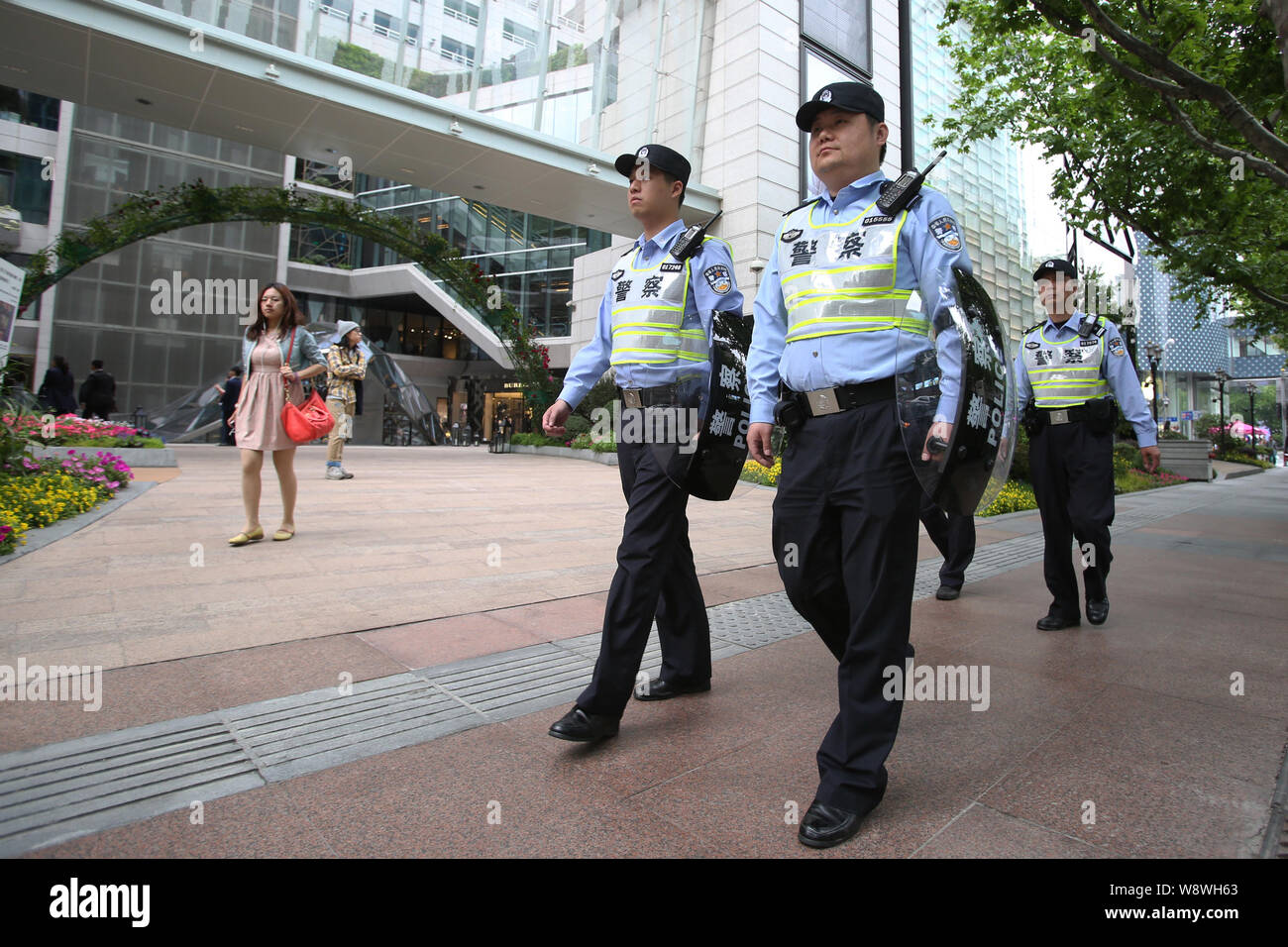 Chinese police officers armed with shields patrol on Huaihai Road in ...