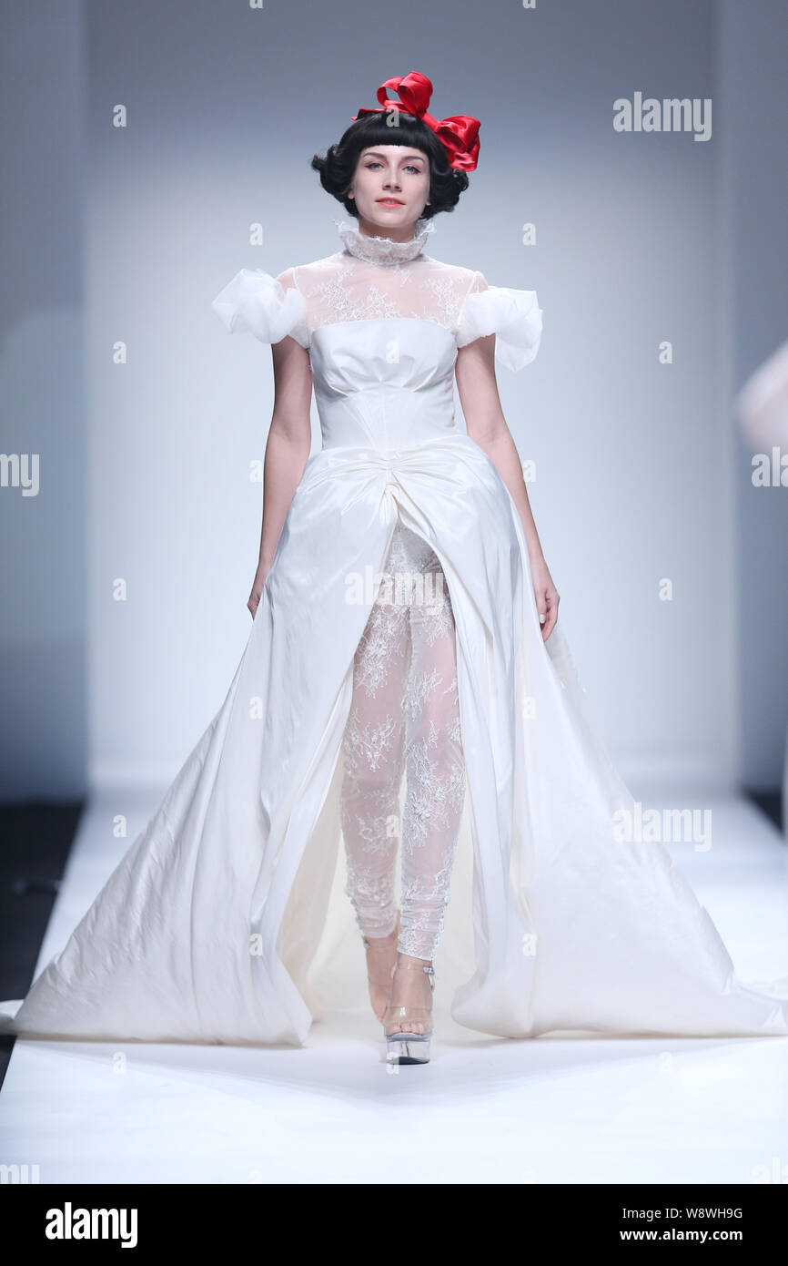 A model displays a new creation at the fashion show of Disney Princess ...