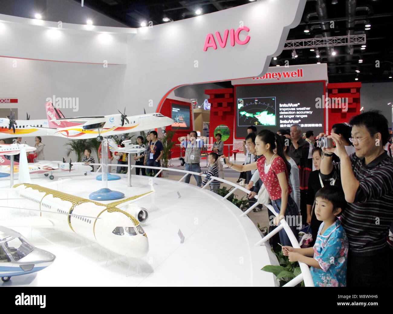--FILE--Visitors take photos of model planes at the stand of AVIC ...