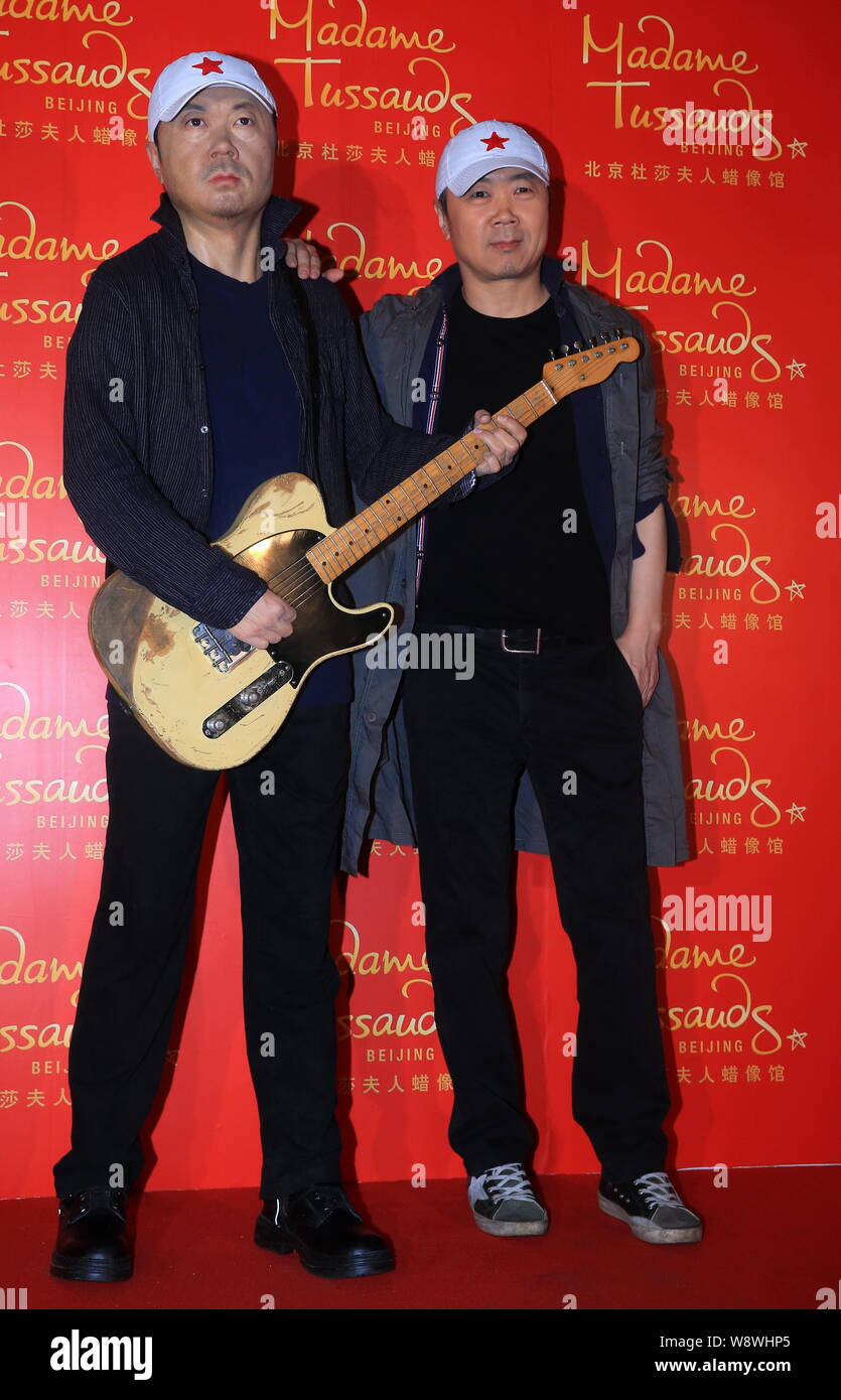 Chinese singer-songwriter Cui Jian, right, poses with the wax figure of ...