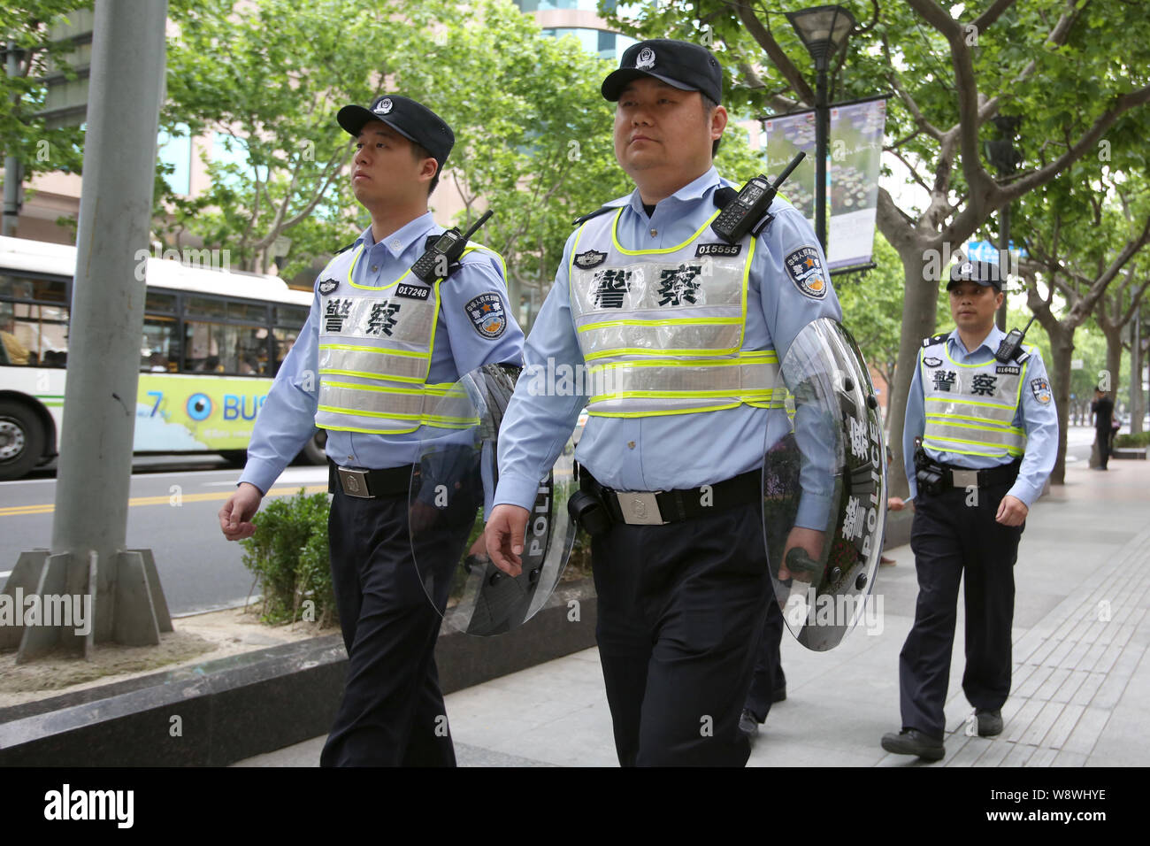 Chinese police officers armed with shields patrol on Huaihai Road in ...