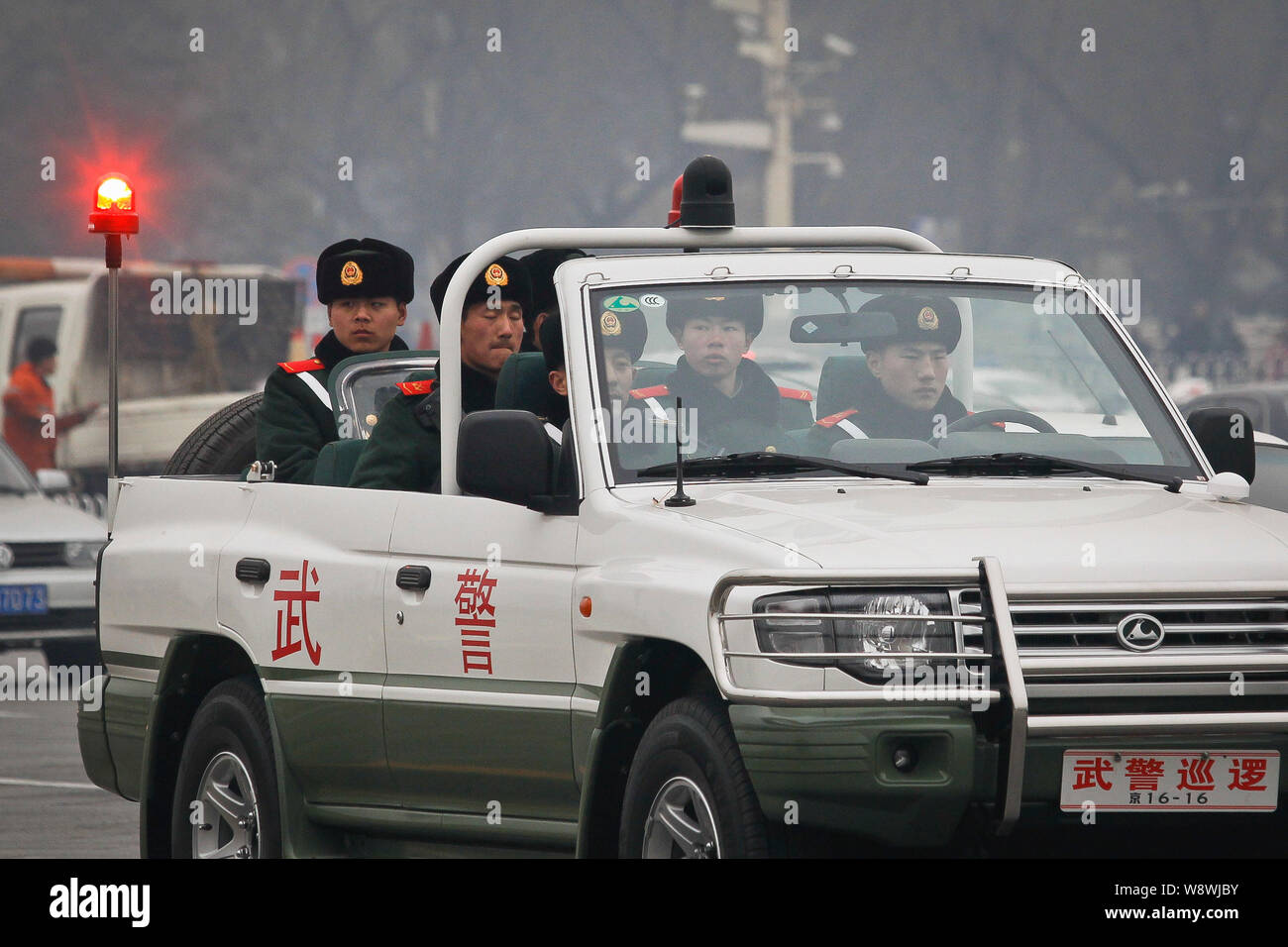 Chinese paramilitary policemen patrol the Tiananmen Square in a car in ...