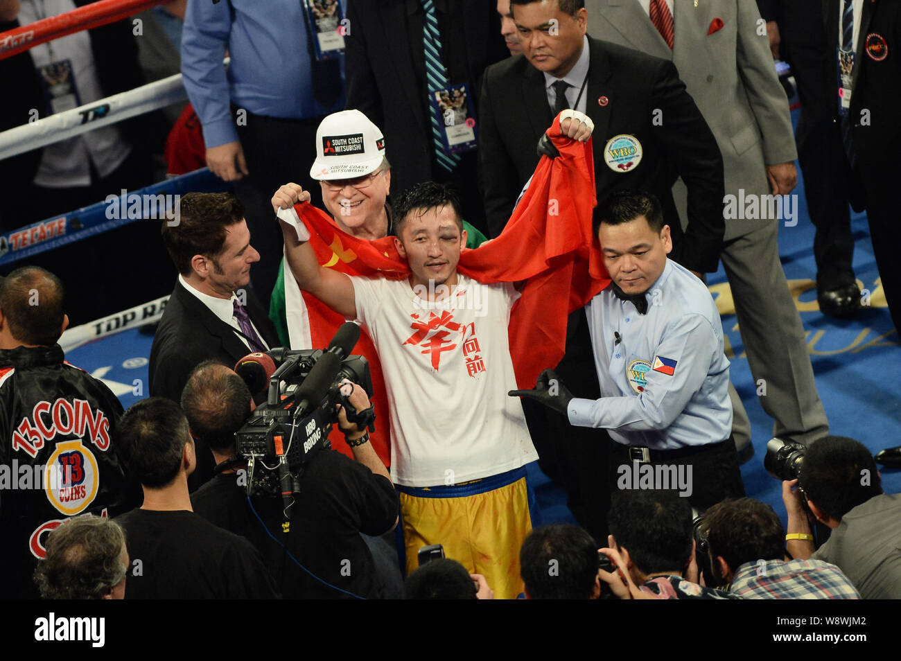 Zou Shiming of China, center, drapes a Chinese national flag to ...