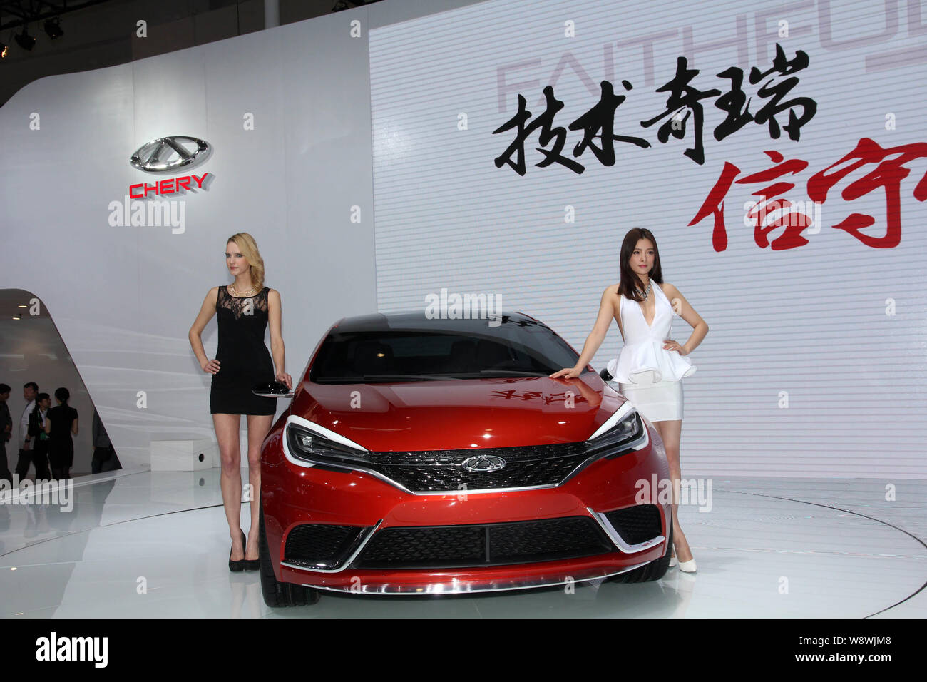 --FILE--Models pose with a new Chery car during the 13th Beijing ...