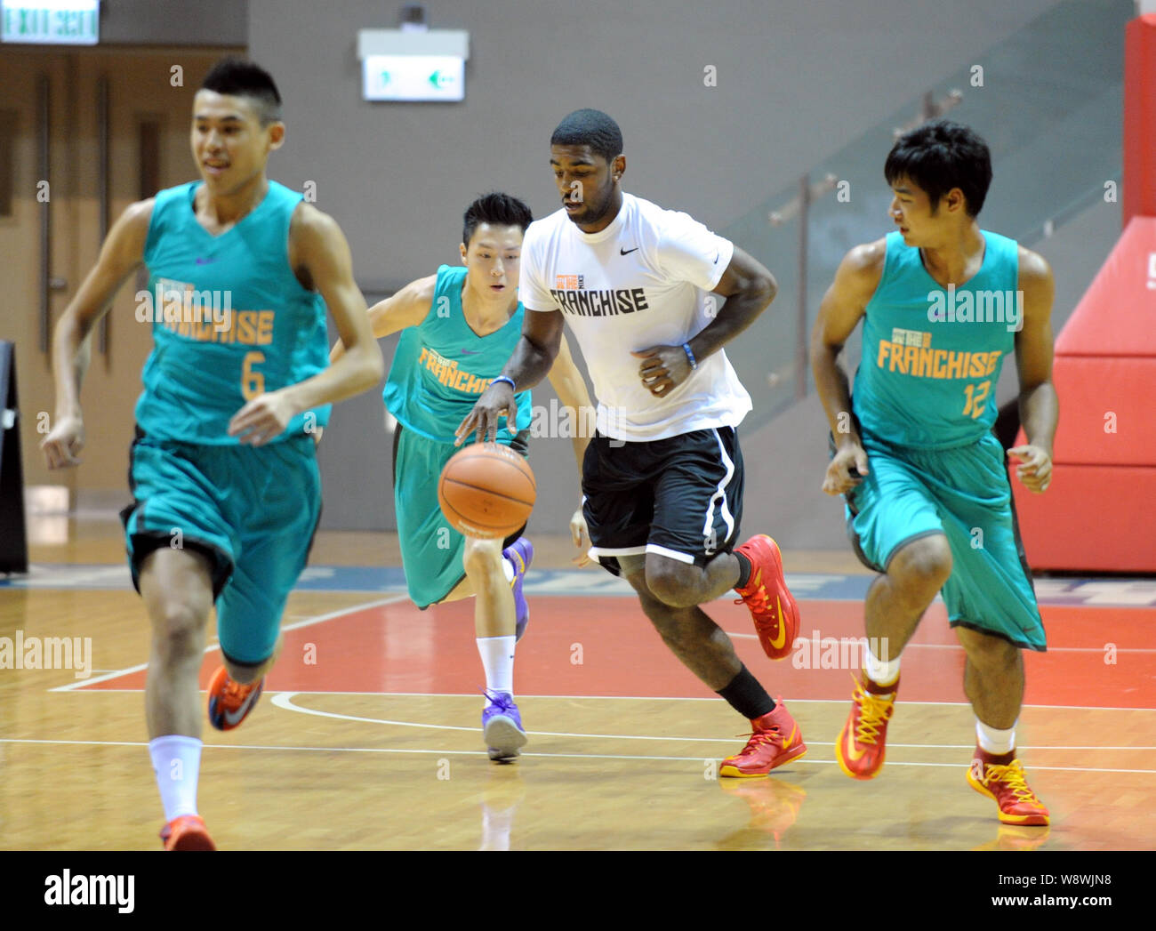 American basketball player Kyrie Irving, second right, dribbles during ...