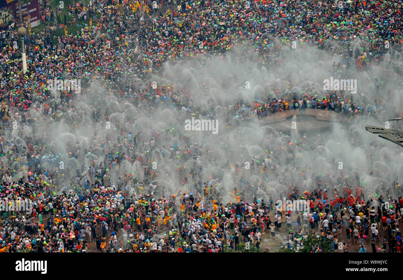 Crowds of local people splash water to celebrate the New Year of Dai ...