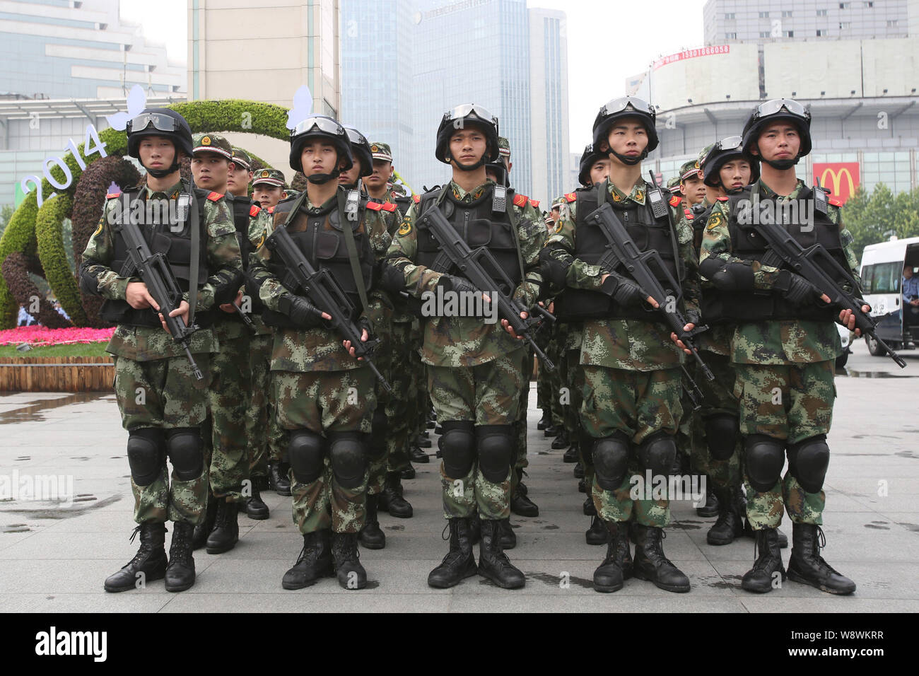 SWAT police officers armed with guns stand guard at the square of the ...