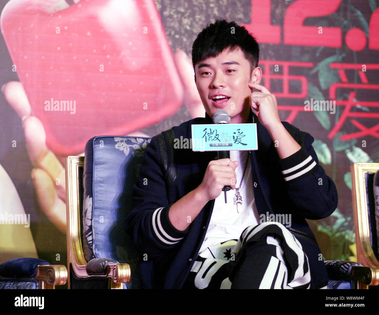 Chinese actor Chen He speaks during a premiere event for his new movie "Love On The Cloud" in ...