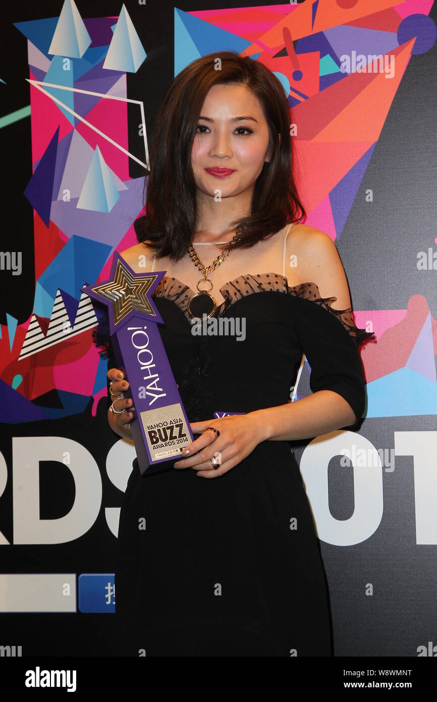 Singer and actress Charlene Choi of Hong Kong pop duo Twins poses with her trophy after the ...