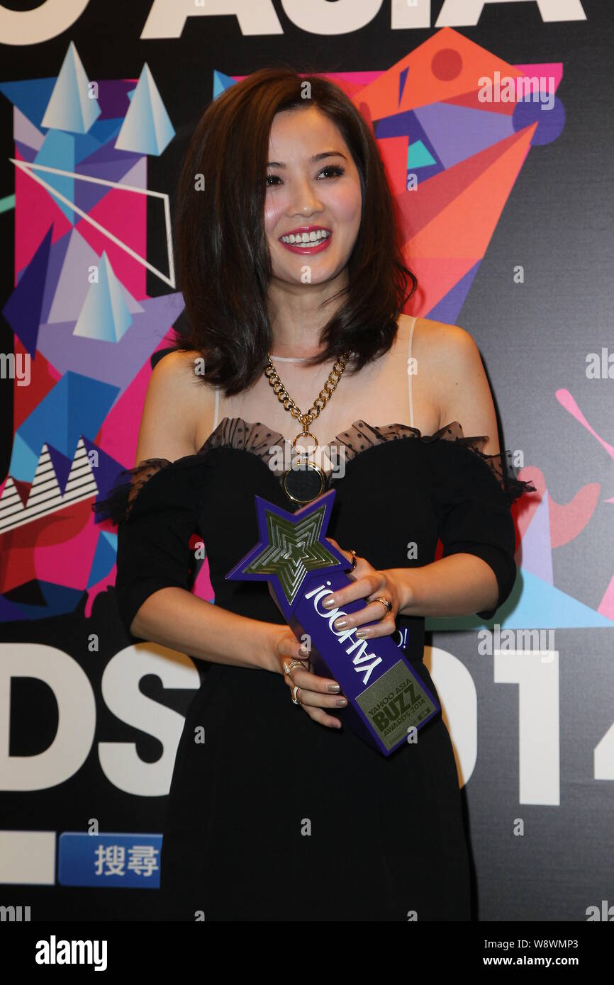 Singer and actress Charlene Choi of Hong Kong pop duo Twins poses with her trophy after the ...