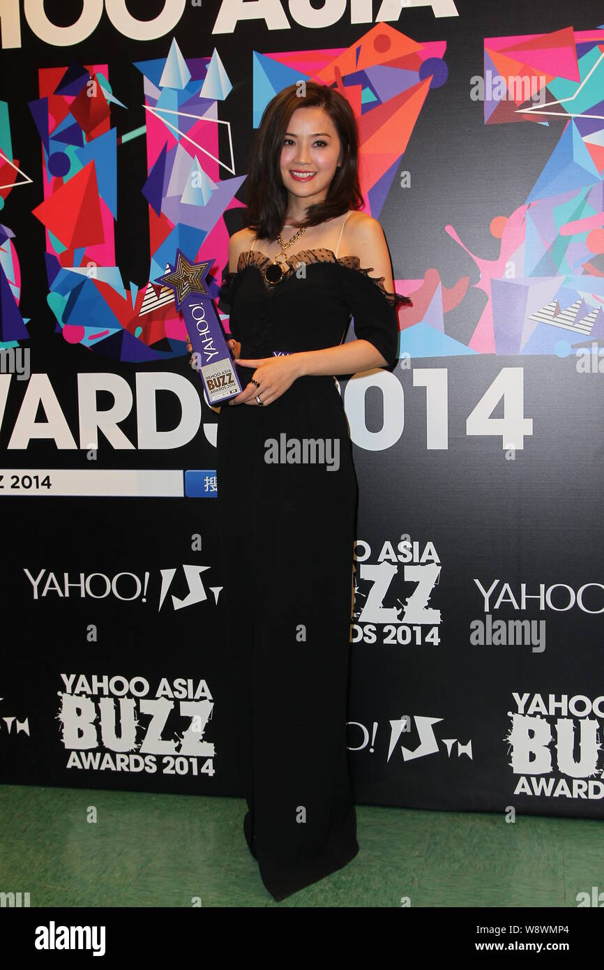 Singer and actress Charlene Choi of Hong Kong pop duo Twins poses with her trophy after the ...