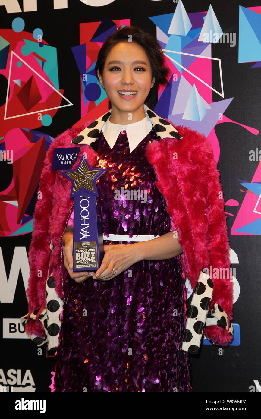 Hong Kong actress Ella Koon poses with her trophy after the presentation ceremony of the Yahoo ...