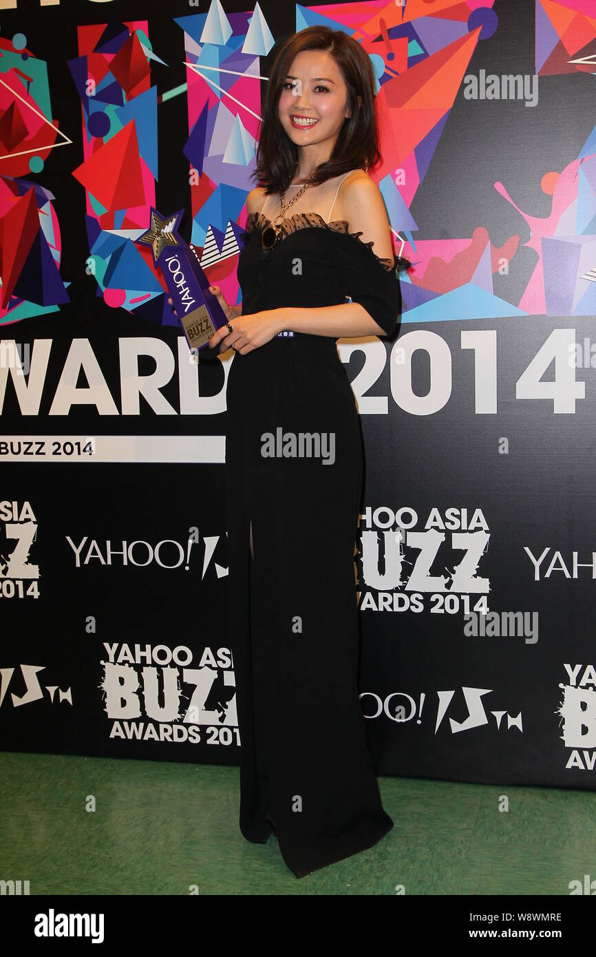Singer and actress Charlene Choi of Hong Kong pop duo Twins poses with her trophy after the ...