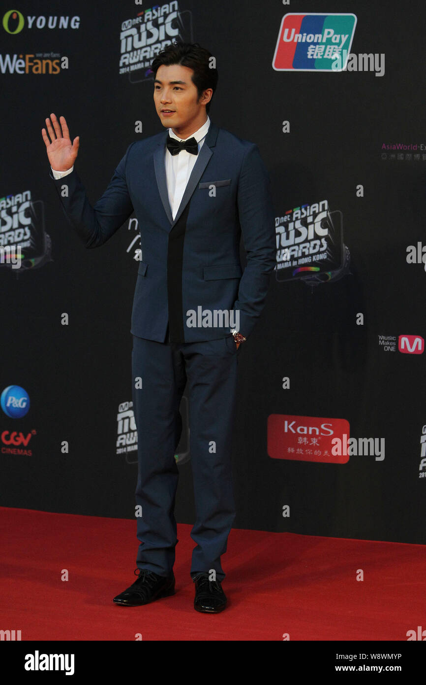 Taiwanese singer and actor Mike He poses on the red carpet as he ...
