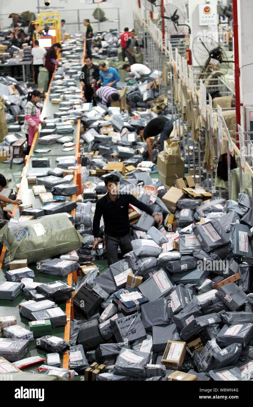 Chinese workers sort parcels, most of which are from online shopping ...