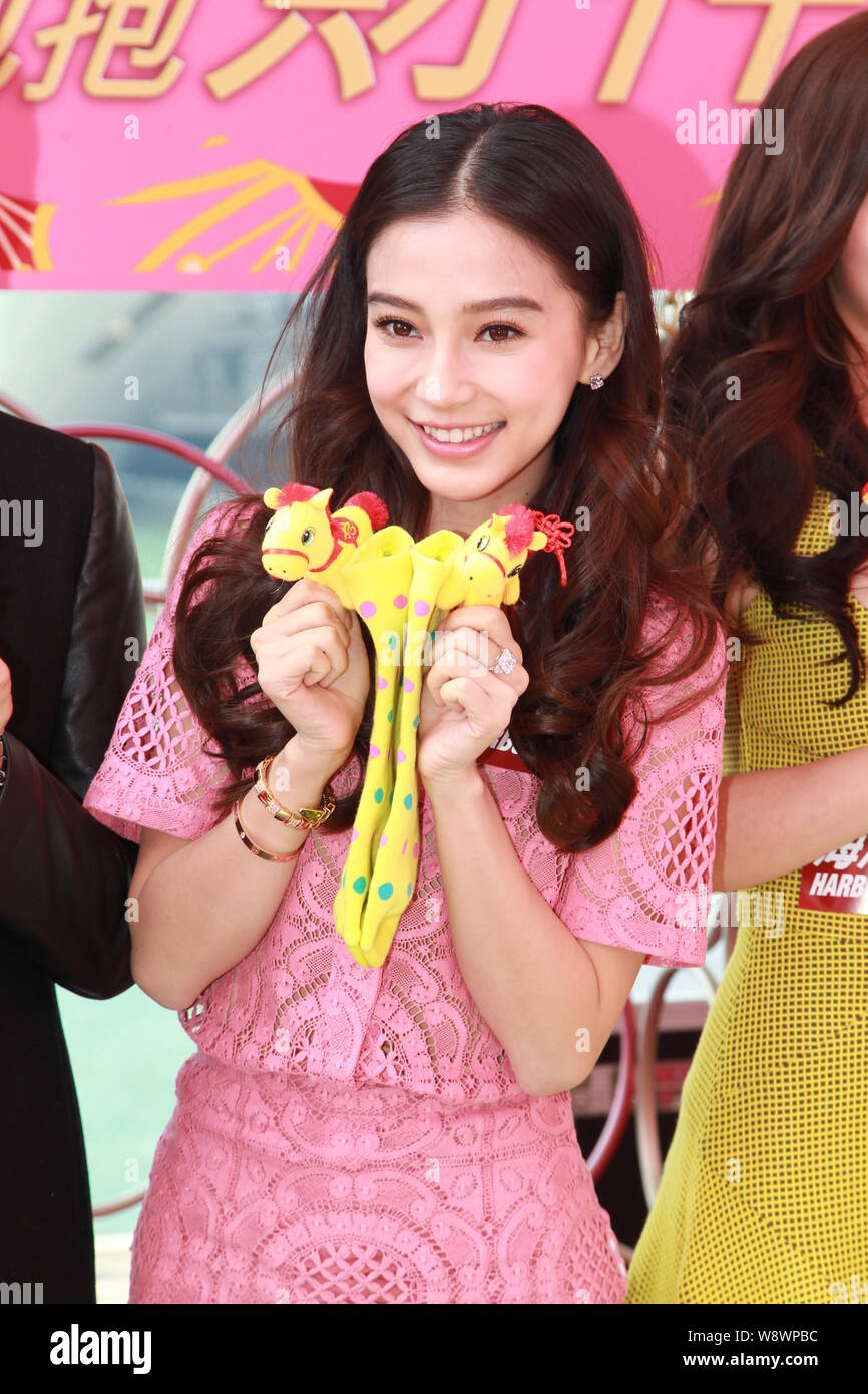 Hong Kong model and actress Angelababy smiles as she poses with toy ...