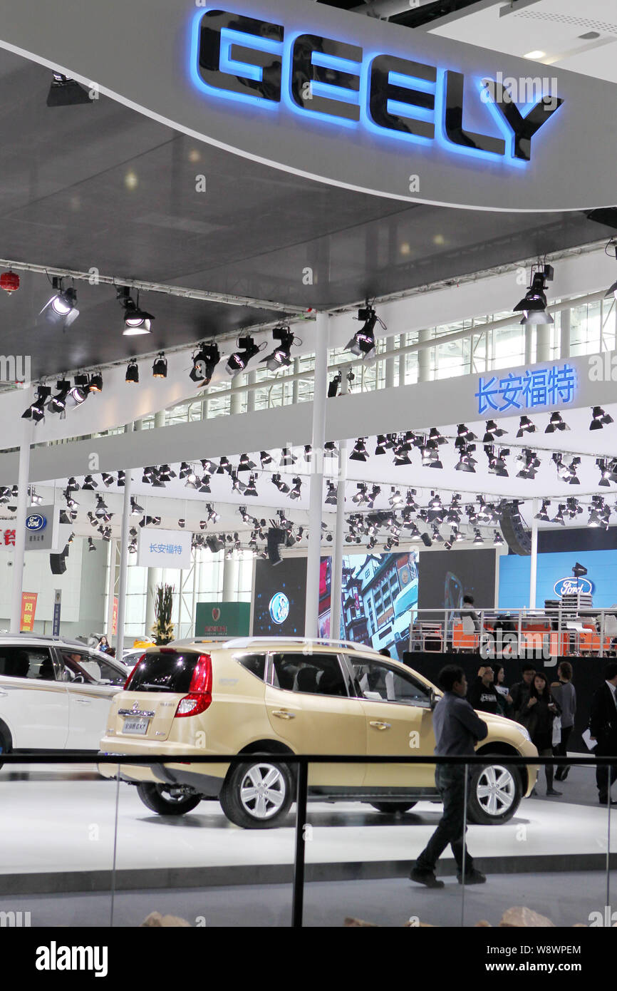 --FILE--A visitor walks past the stand of Geely during the 11th China ...